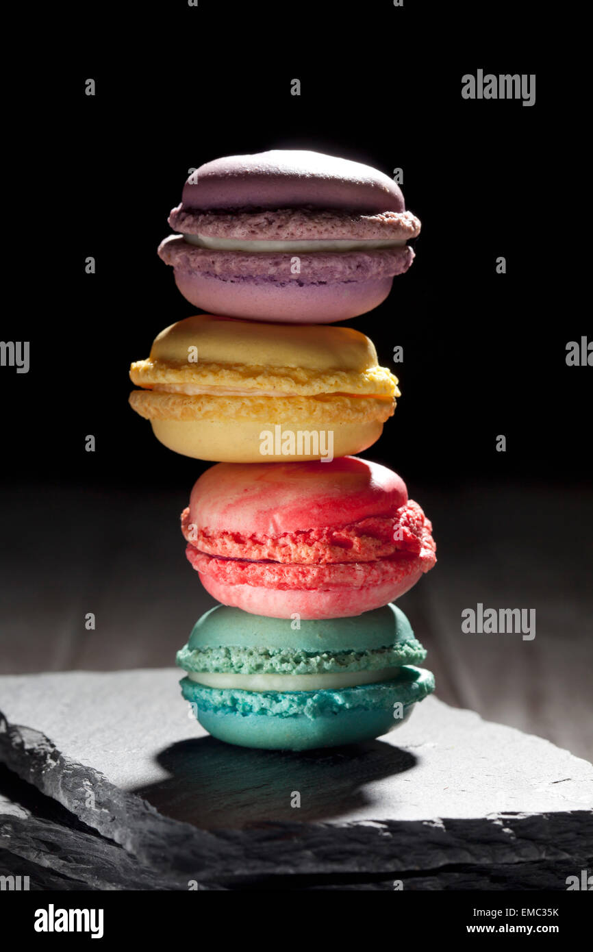 Stack of four different macarons on slate Stock Photo - Alamy