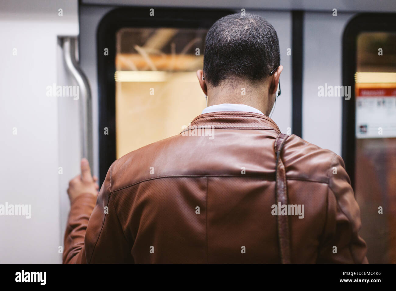 Back view of man on the subway train Stock Photo - Alamy