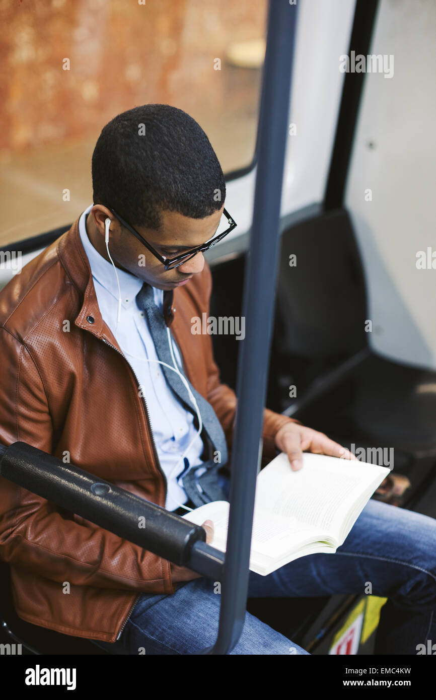 Man reading book on train hi-res stock photography and images - Alamy