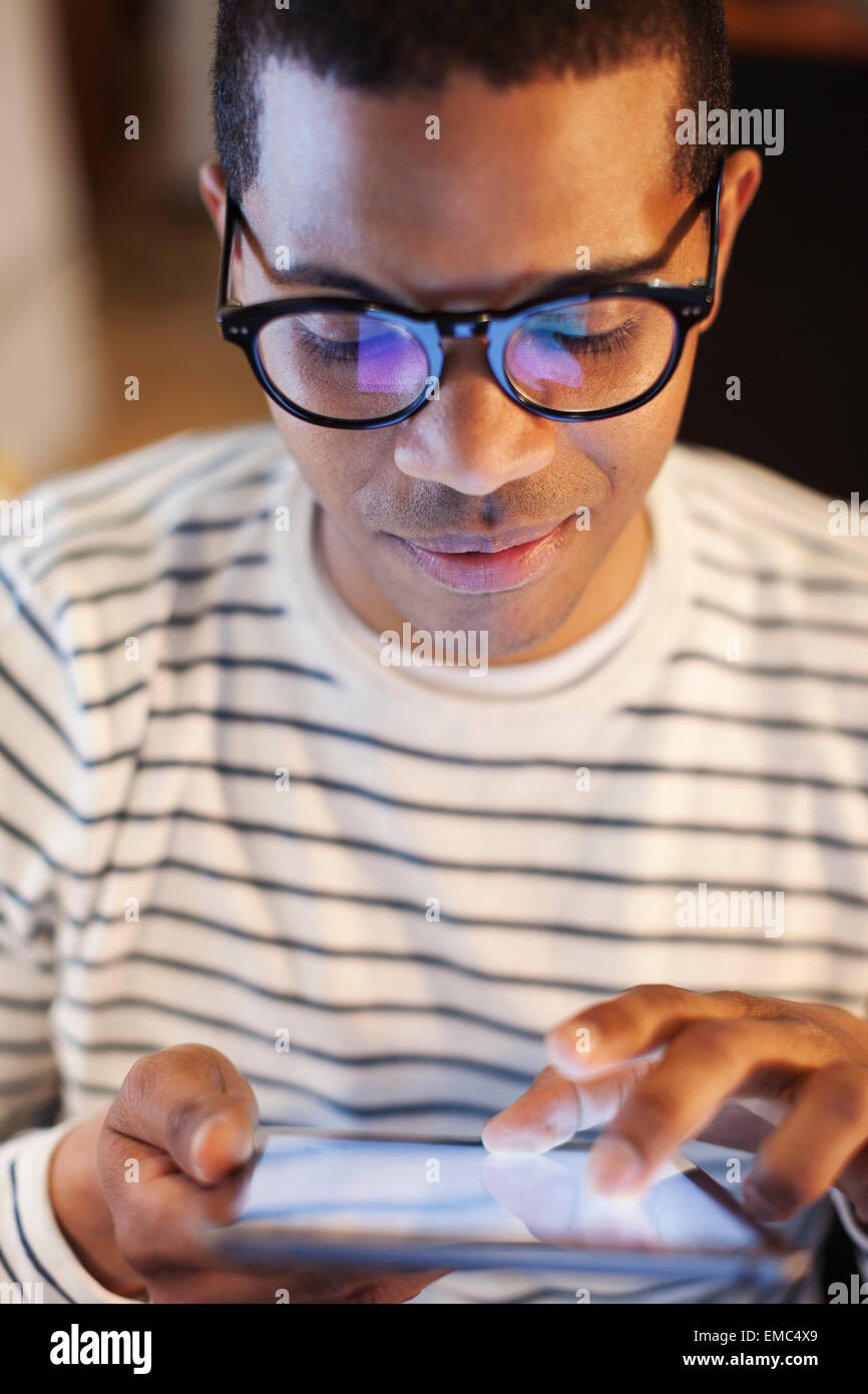 Young man using mini tablet Stock Photo - Alamy