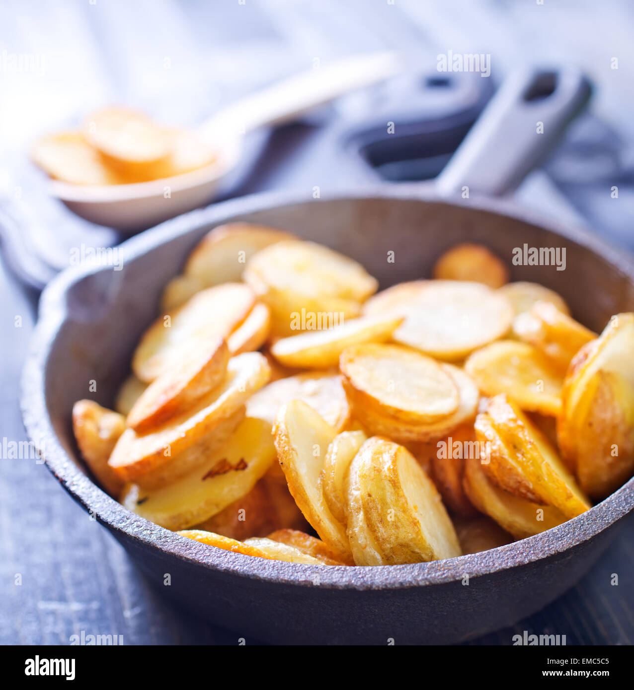 fried potato in pan and on a table Stock Photo - Alamy