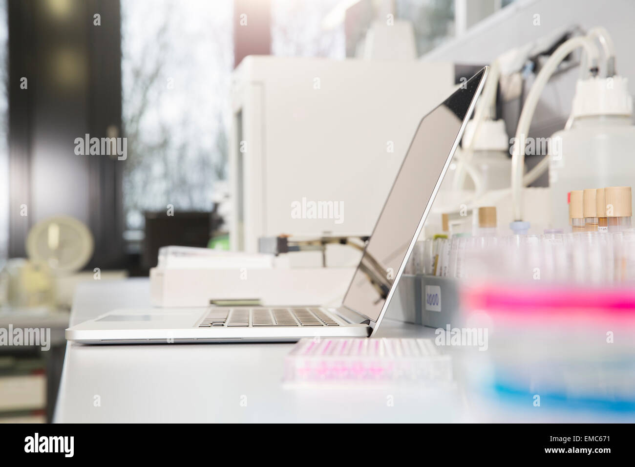 Laptop on laboratory desk Stock Photo - Alamy