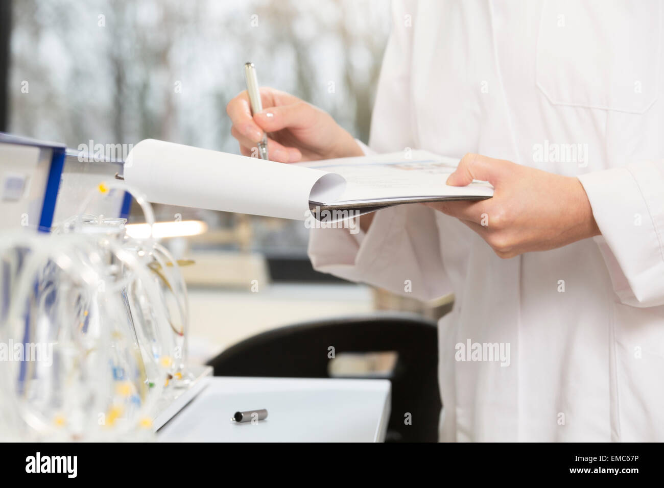 Scientist checking research results writing hi-res stock photography ...