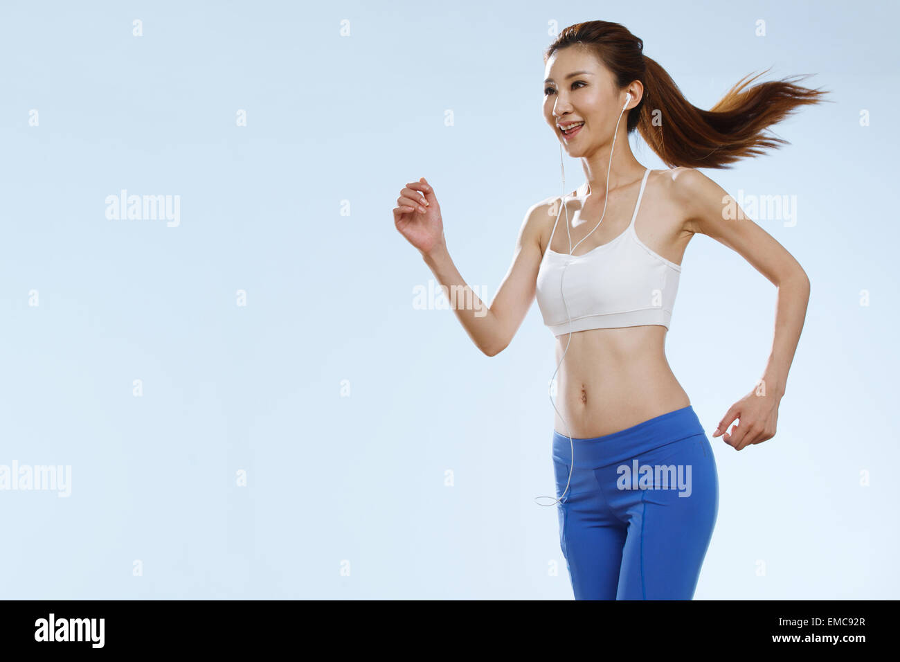 A young woman running outdoors Stock Photo - Alamy