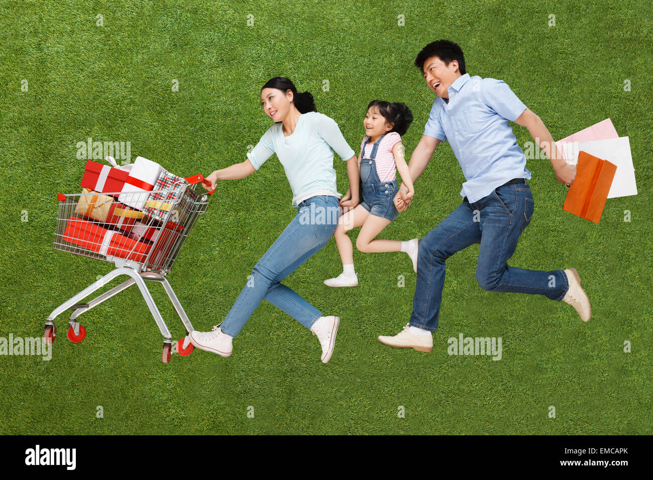The joy of a family of three shopping Stock Photo - Alamy