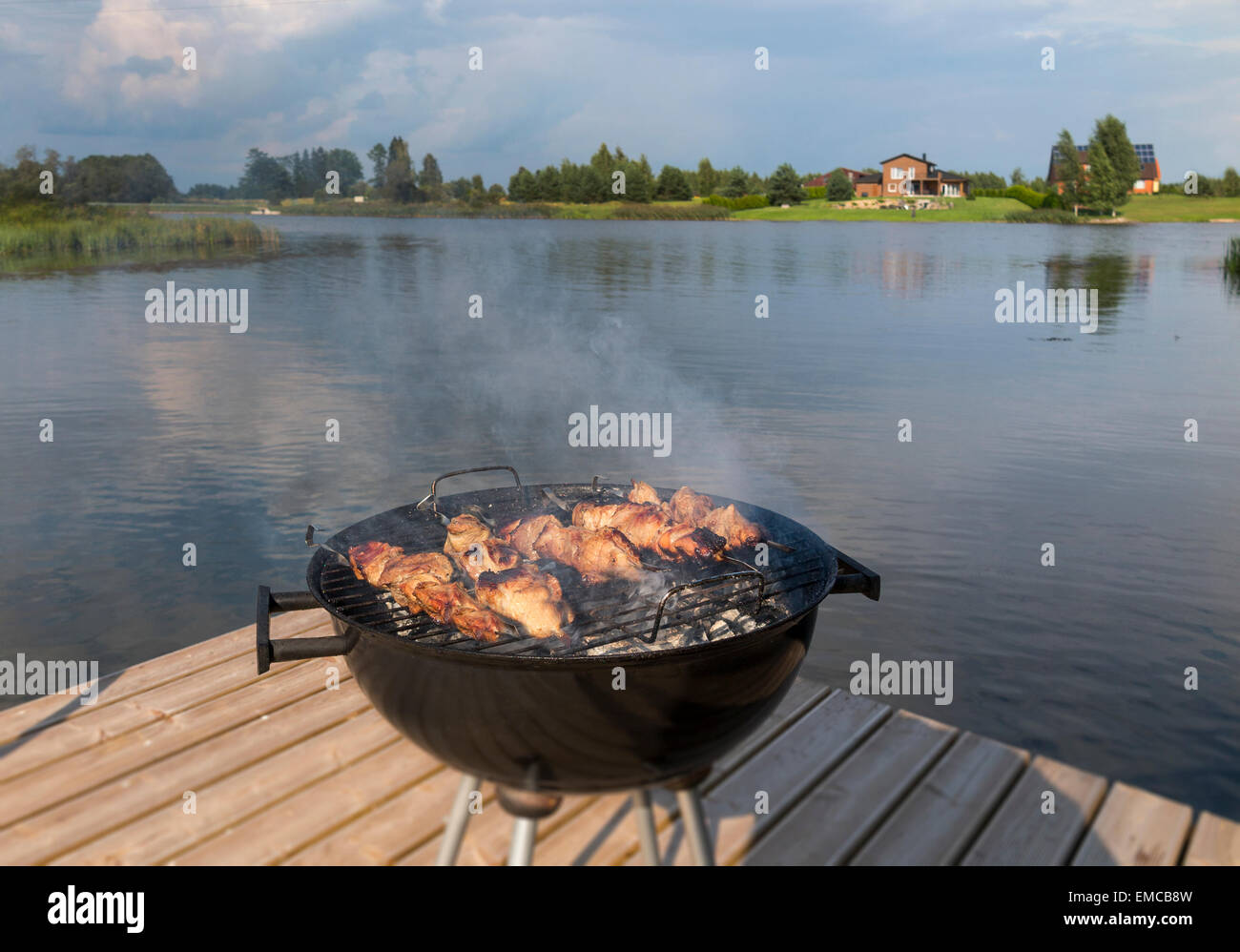 Estonia, barbecue grill on wooden platform by lake Stock Photo - Alamy