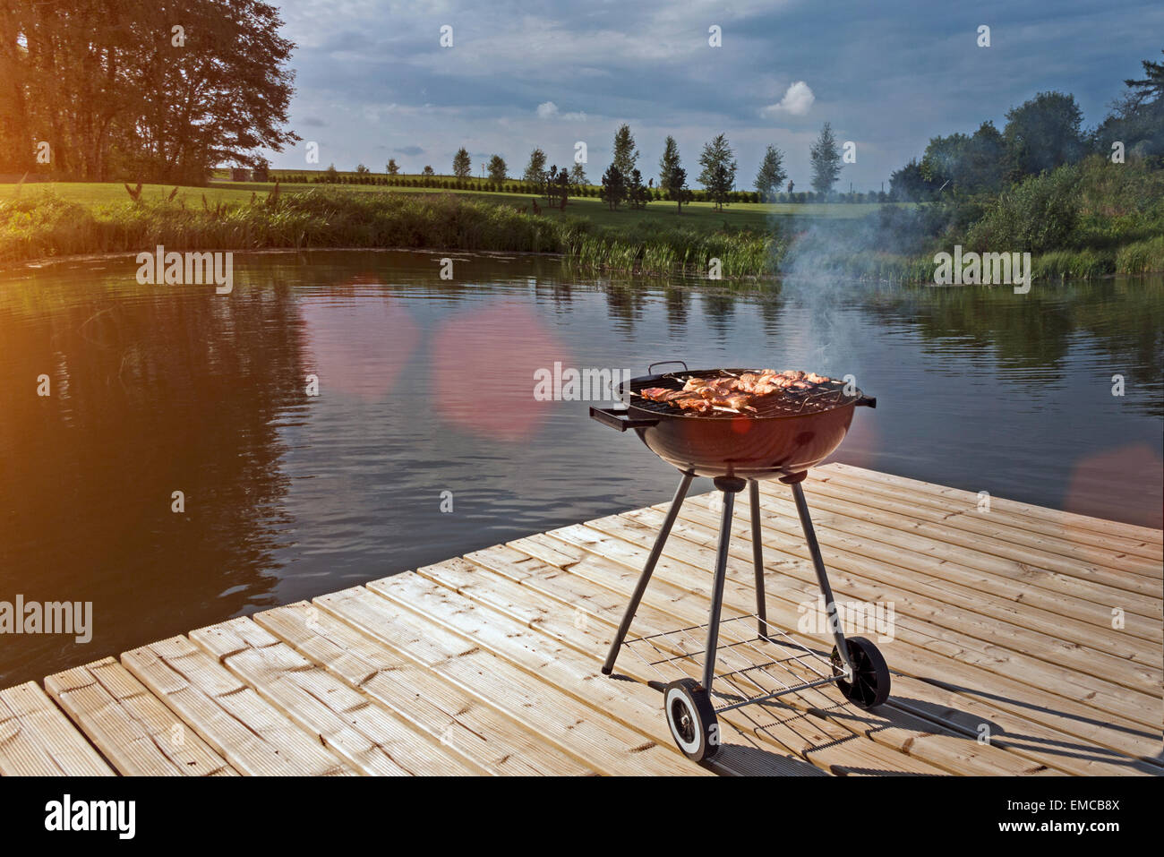 Estonia, barbecue grill on wooden platform by lake Stock Photo - Alamy