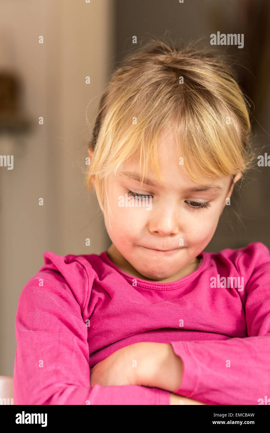 Portrait of a blond girl being defiant Stock Photo - Alamy