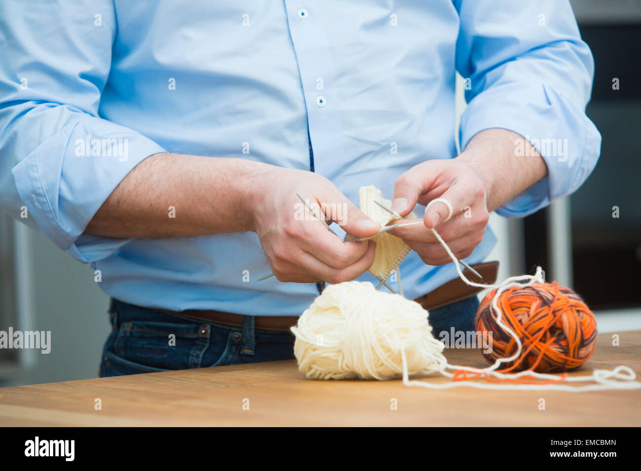 Man's hands knitting Stock Photo - Alamy
