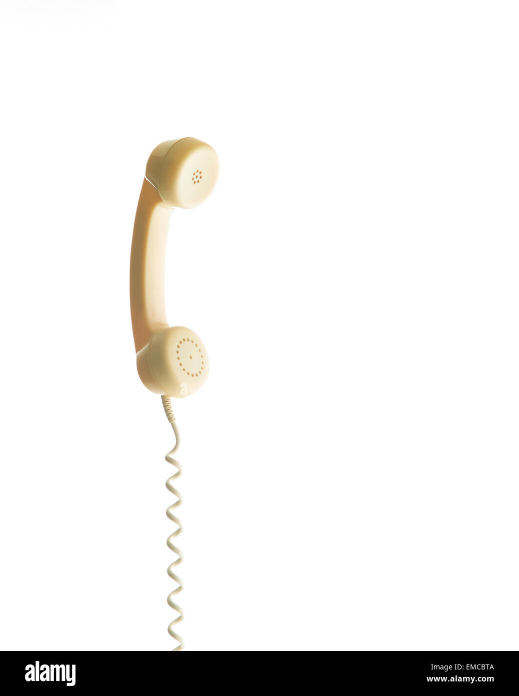 yellow telephone receiver on white background Stock Photo - Alamy