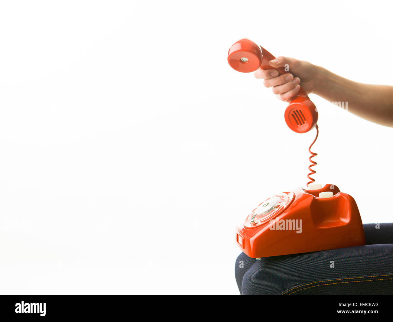 woman answering red phone, on white background. copy space available ...