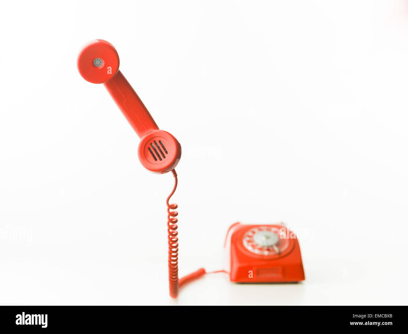 vintage red phone with handset in the air, isolated on white background ...