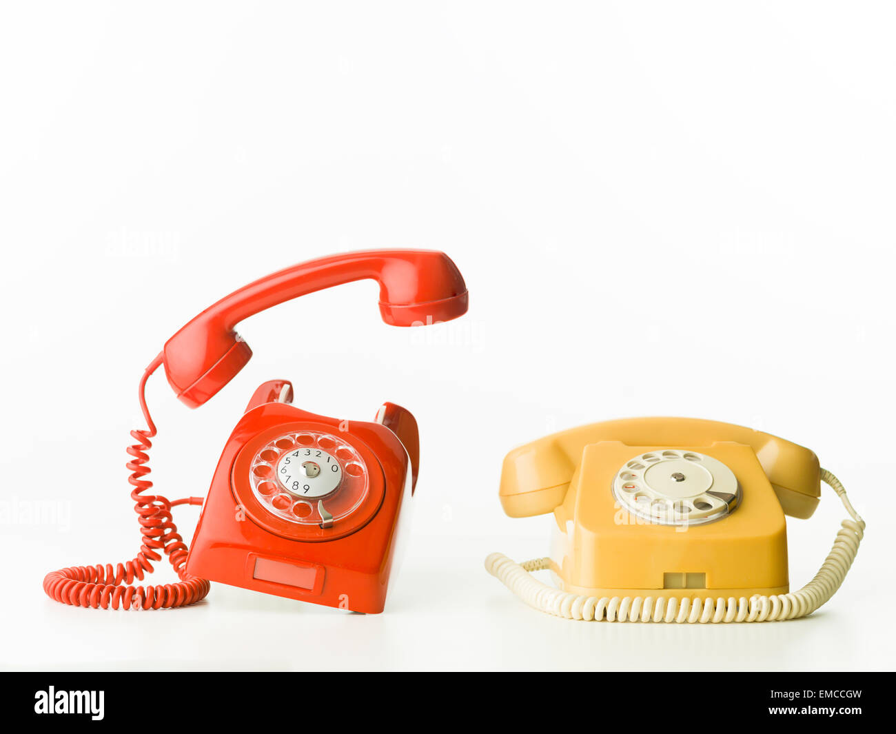 front view of two vintage phones ringing, isolated on white background ...