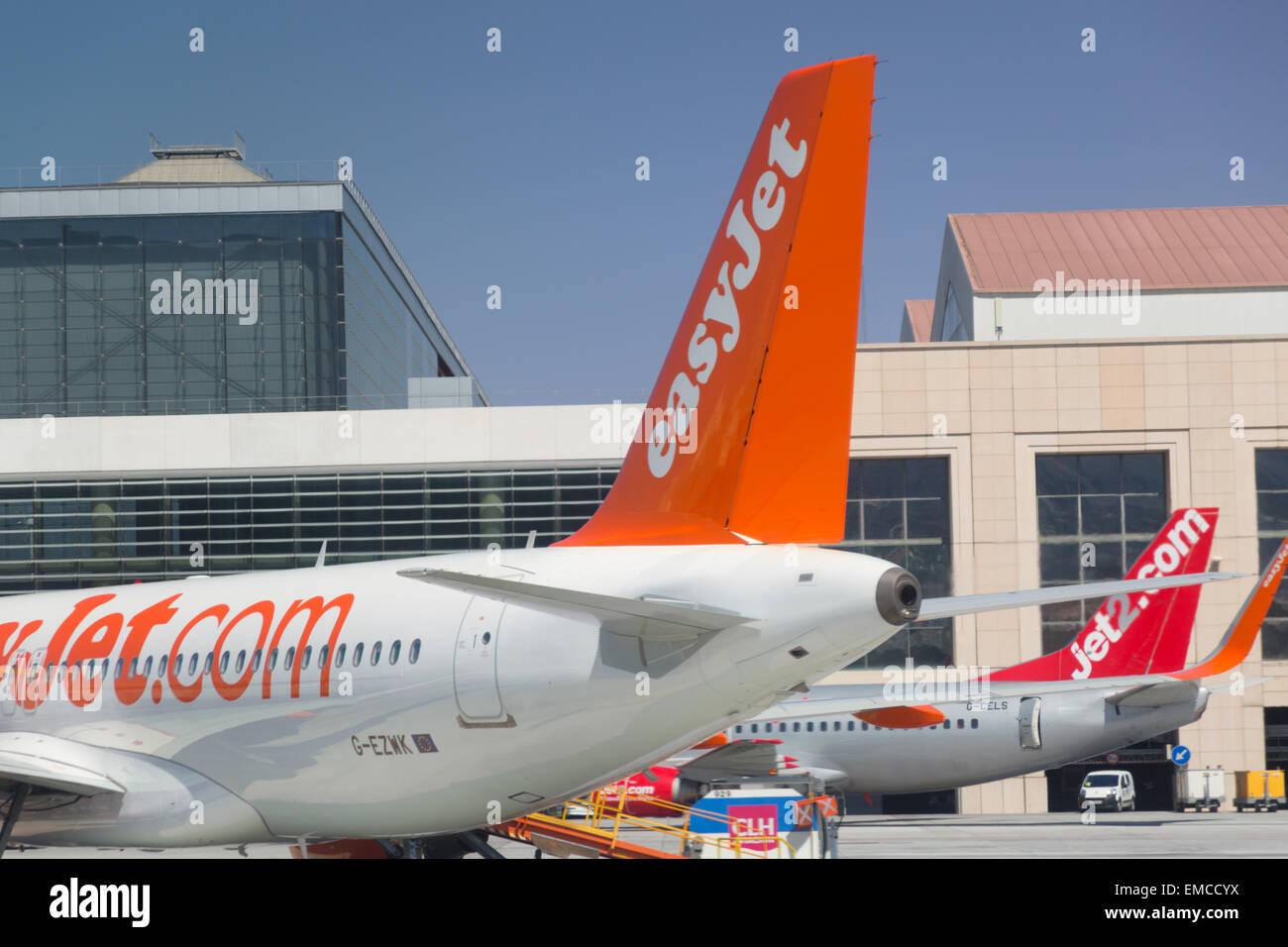 Easyjet airplane at the jet bridge on the runway at Malaga airport ...