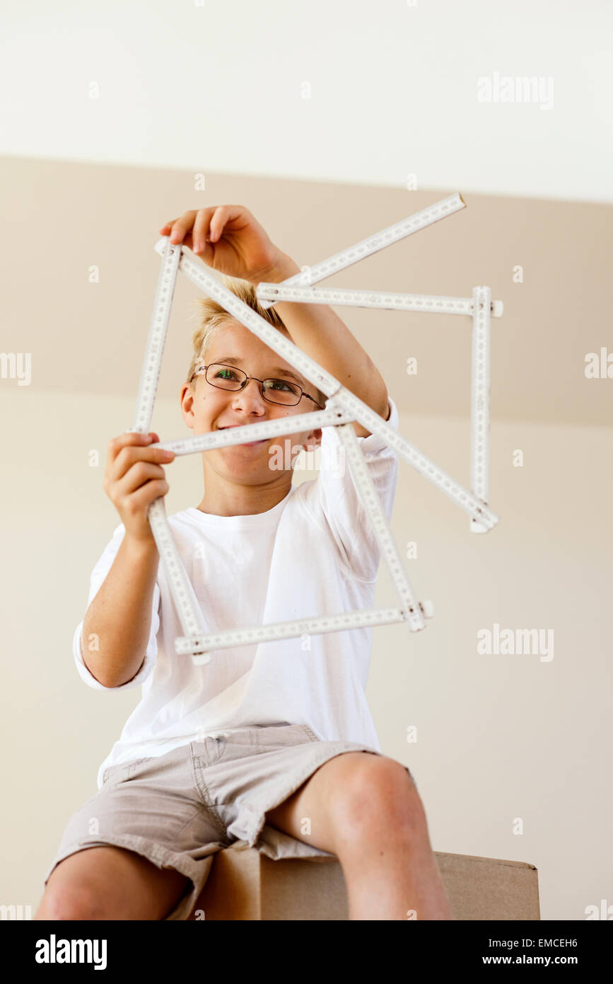 Boy with pocket rule formed like a house Stock Photo - Alamy