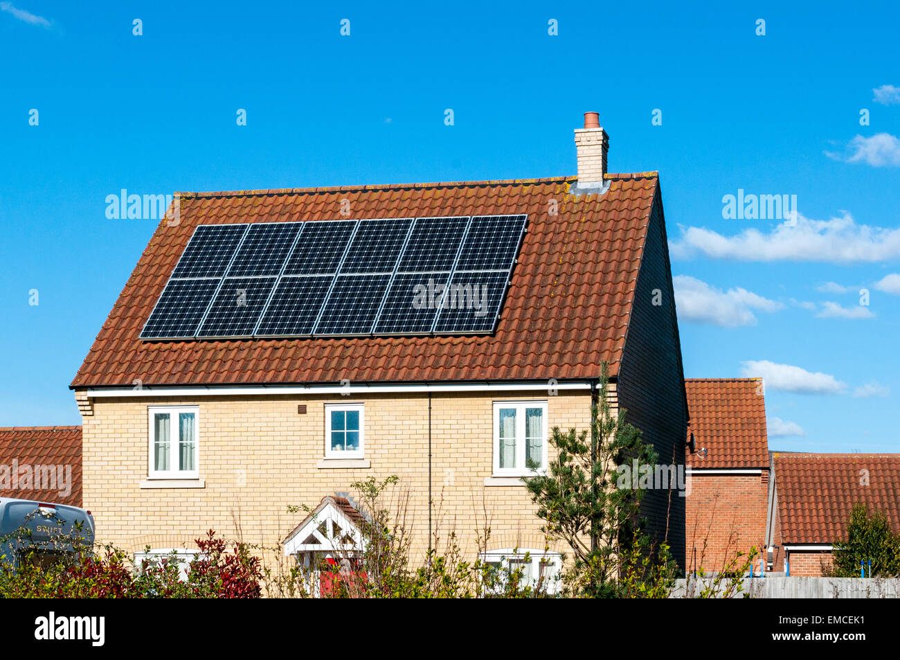 Solar photovoltaic panel array on house roof against a blue sky Stock ...