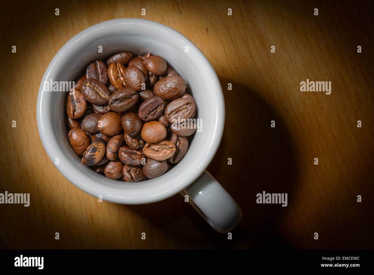 Nice cup of coffe with toasted coffee seeds inside on wood background ...