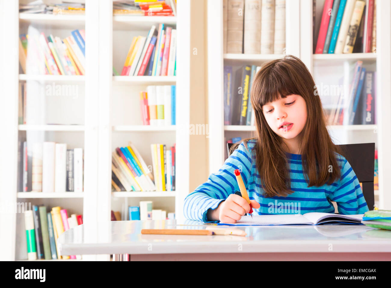 Girl doing homework Stock Photo - Alamy