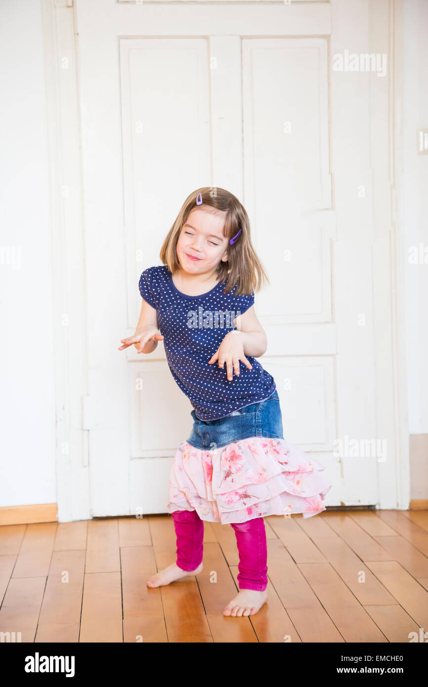 Girl dancing at wooden door Stock Photo - Alamy