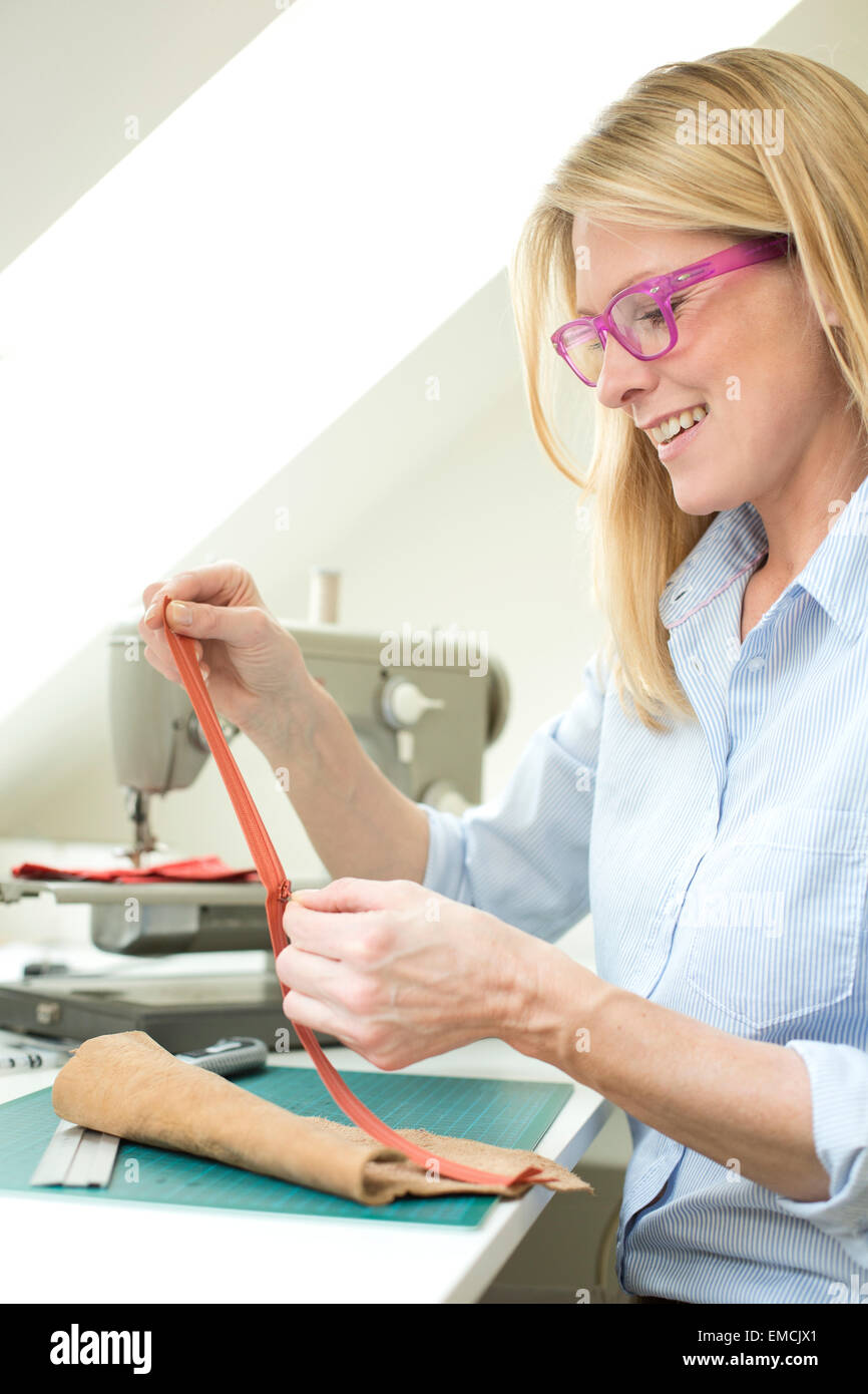 Smiling woman tailoring Stock Photo - Alamy