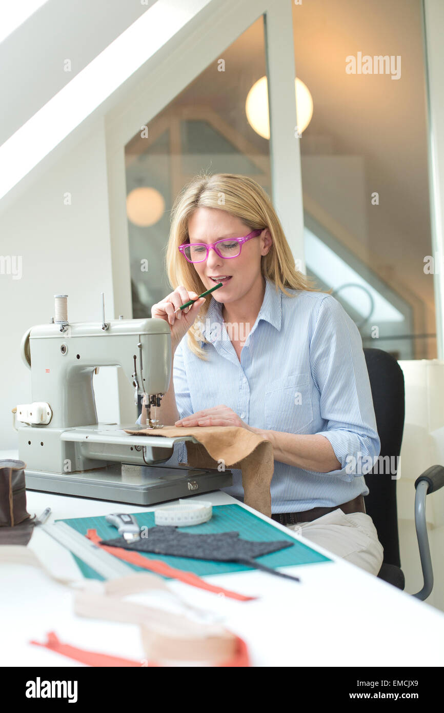 Woman working on sewing machine Stock Photo - Alamy