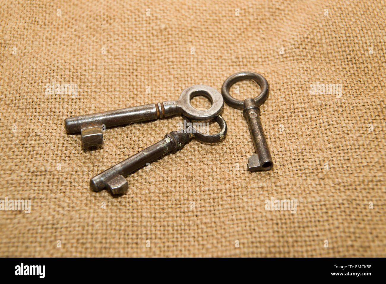 Three vintage keys to the safe on old cloth Stock Photo - Alamy