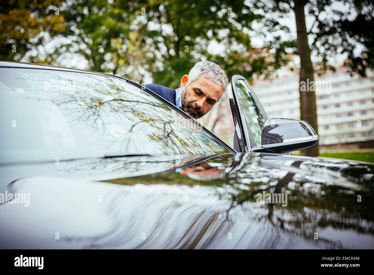 Man getting into his car Stock Photo - Alamy