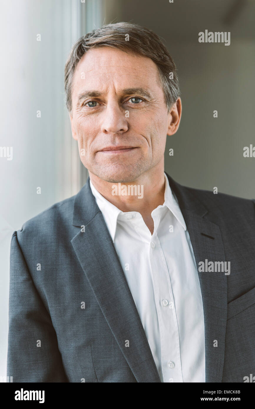 Portrait of smiling businessman Stock Photo - Alamy