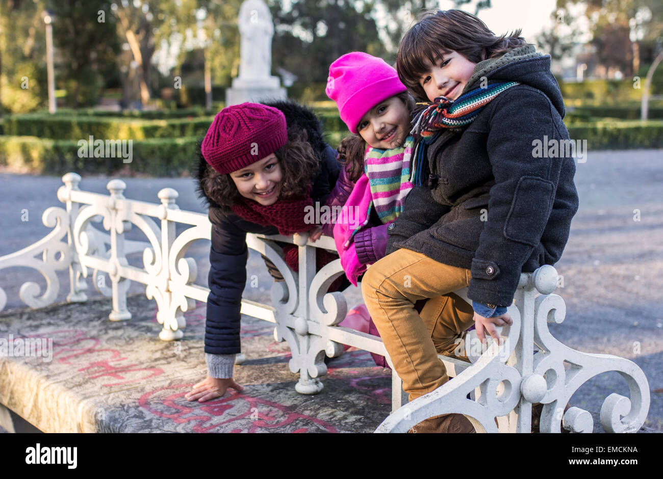 Side by side sitting in a row childhood smiling hi-res stock ...