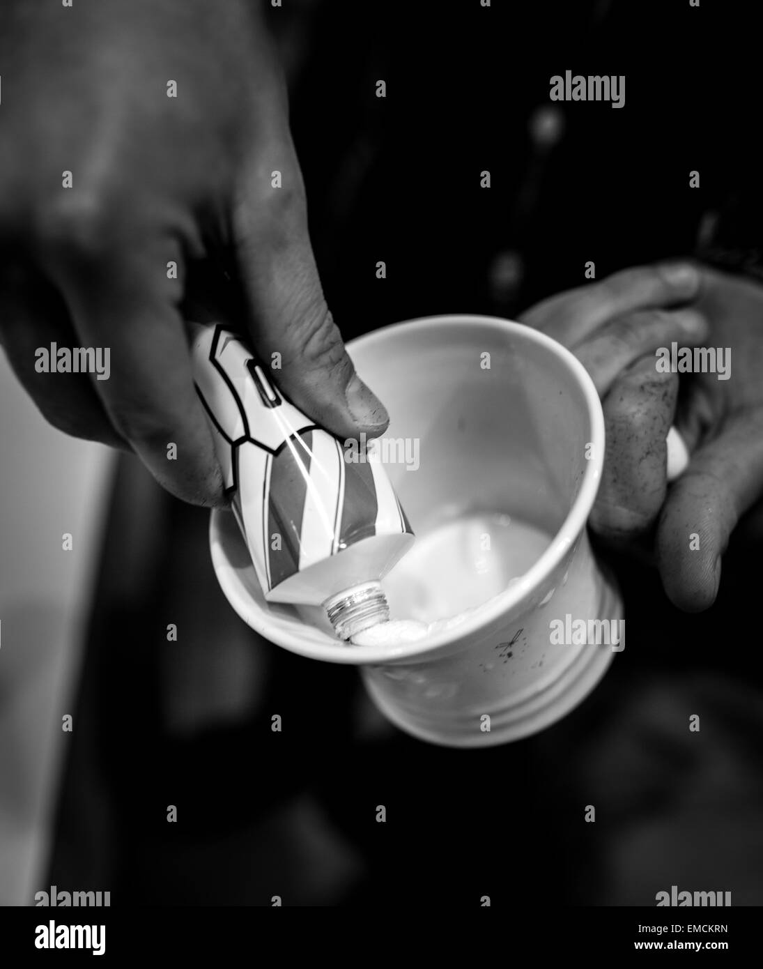 Man's hand pressing tube of shaving cream Stock Photo - Alamy