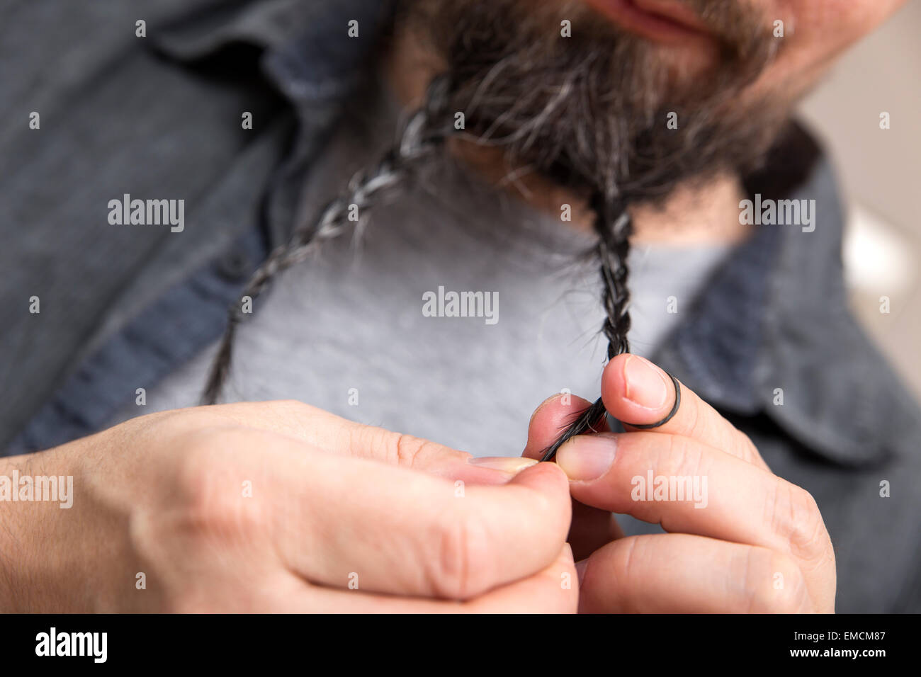 Man braiding his beard Stock Photo - Alamy
