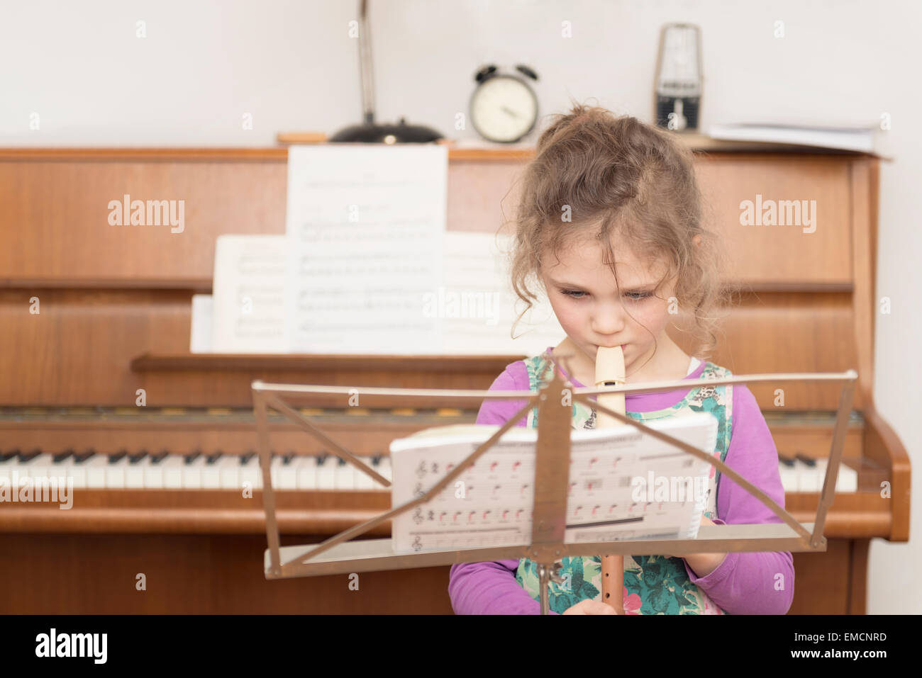Girl at music stand playing recorder Stock Photo - Alamy