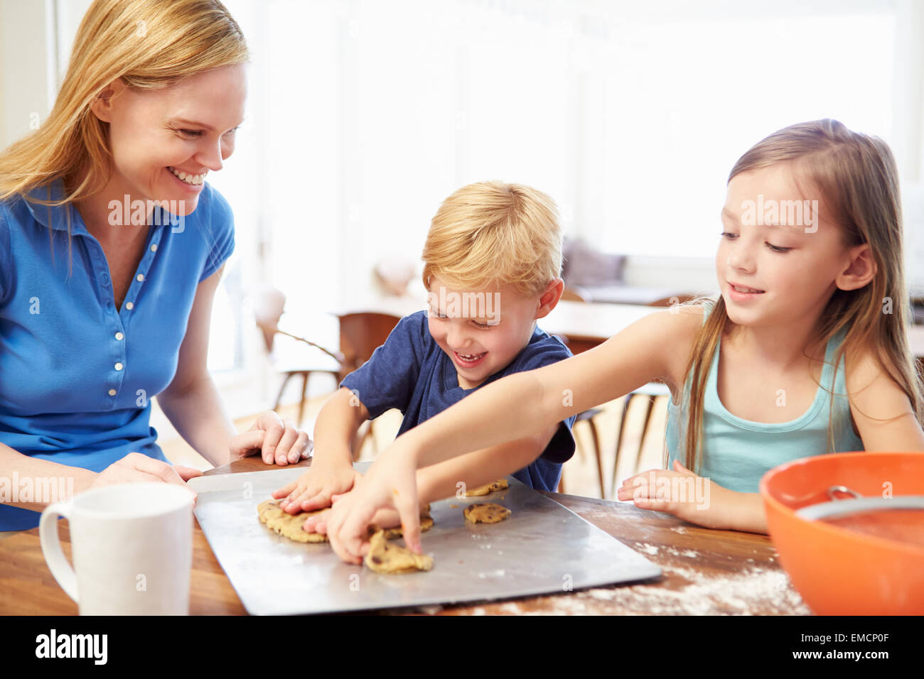 Mother And Children Baking Cookies Together At Home Stock Photo - Alamy
