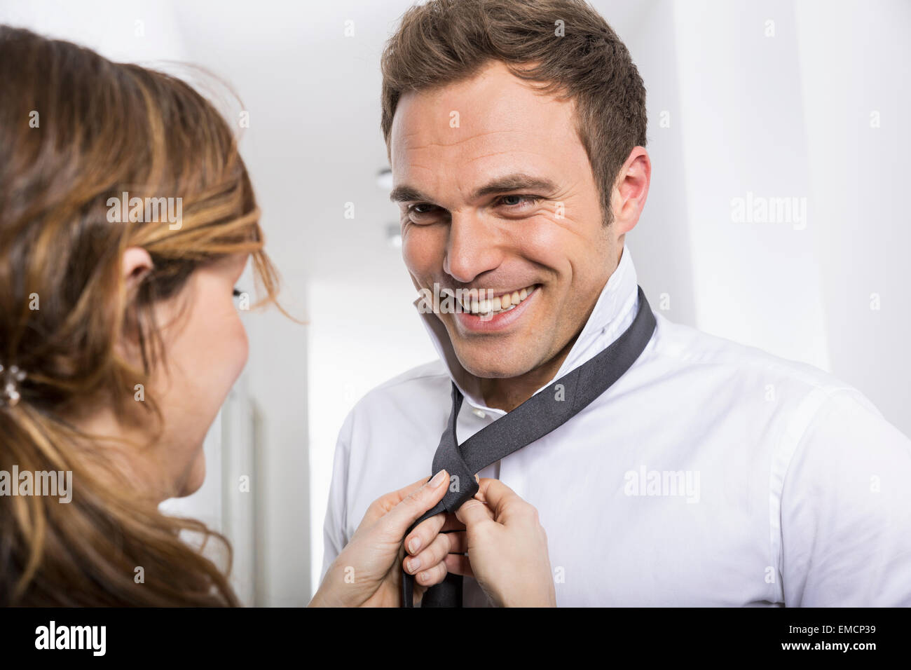 Woman binding man tie hi-res stock photography and images - Alamy