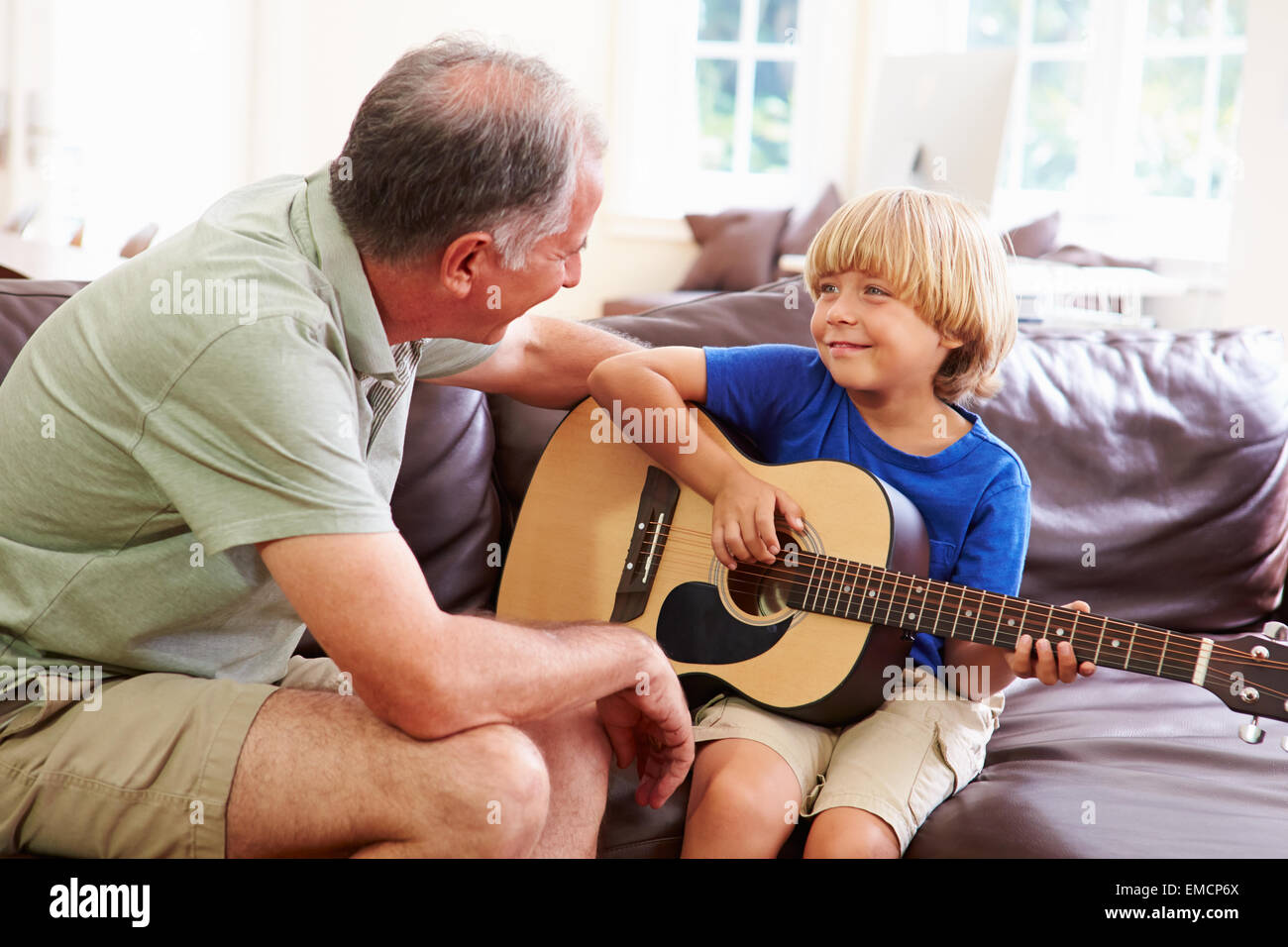 Grandfather grandson playing guitar together hi-res stock photography ...