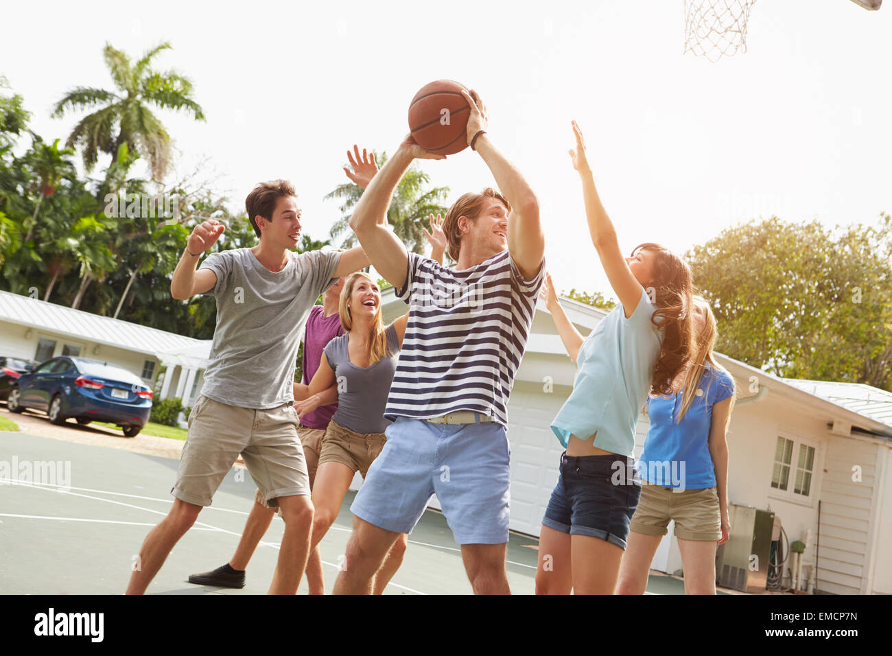 Group Of Young Friends Playing Basketball Match Stock Photo - Alamy