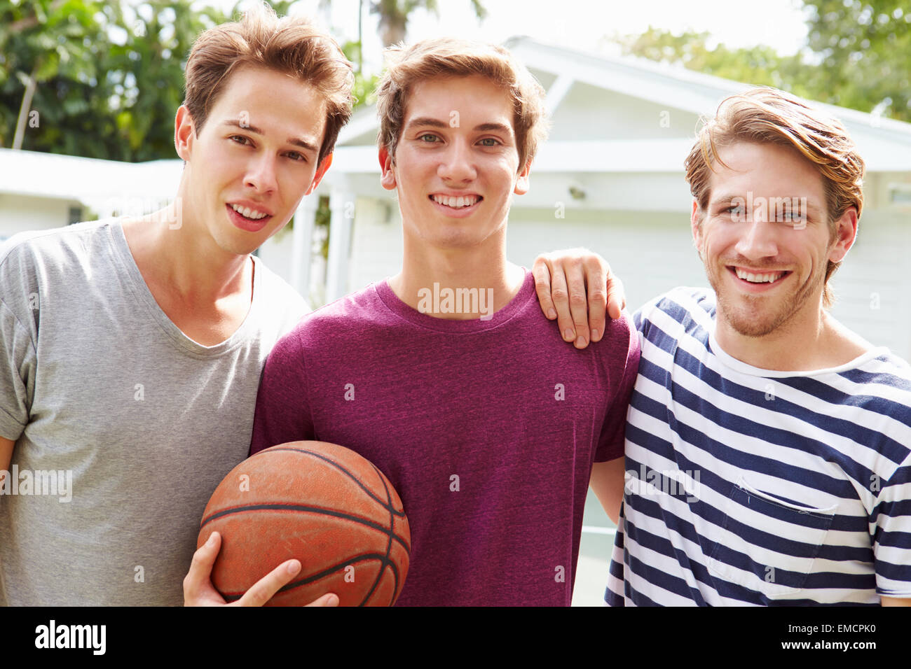 Portrait Of Young Men Playing Basketball Match Stock Photo - Alamy