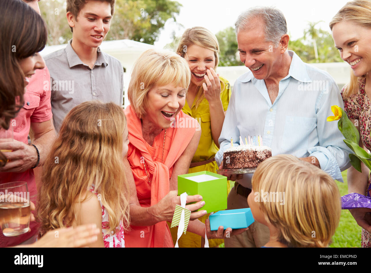 Multi Generation Family Celebrating Birthday In Garden Stock Photo - Alamy