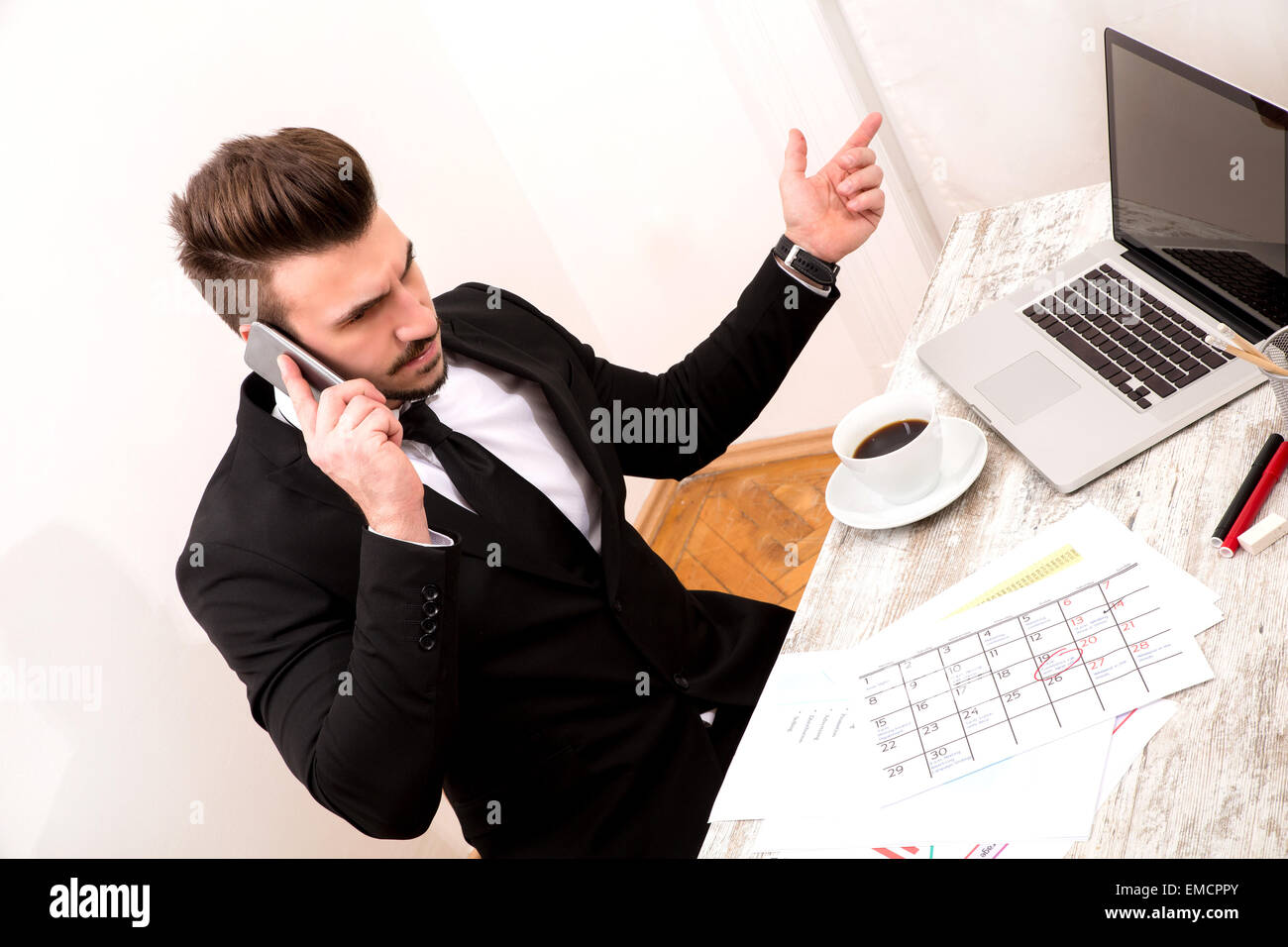 Businessman checking appointments in the calendar at the office and ...