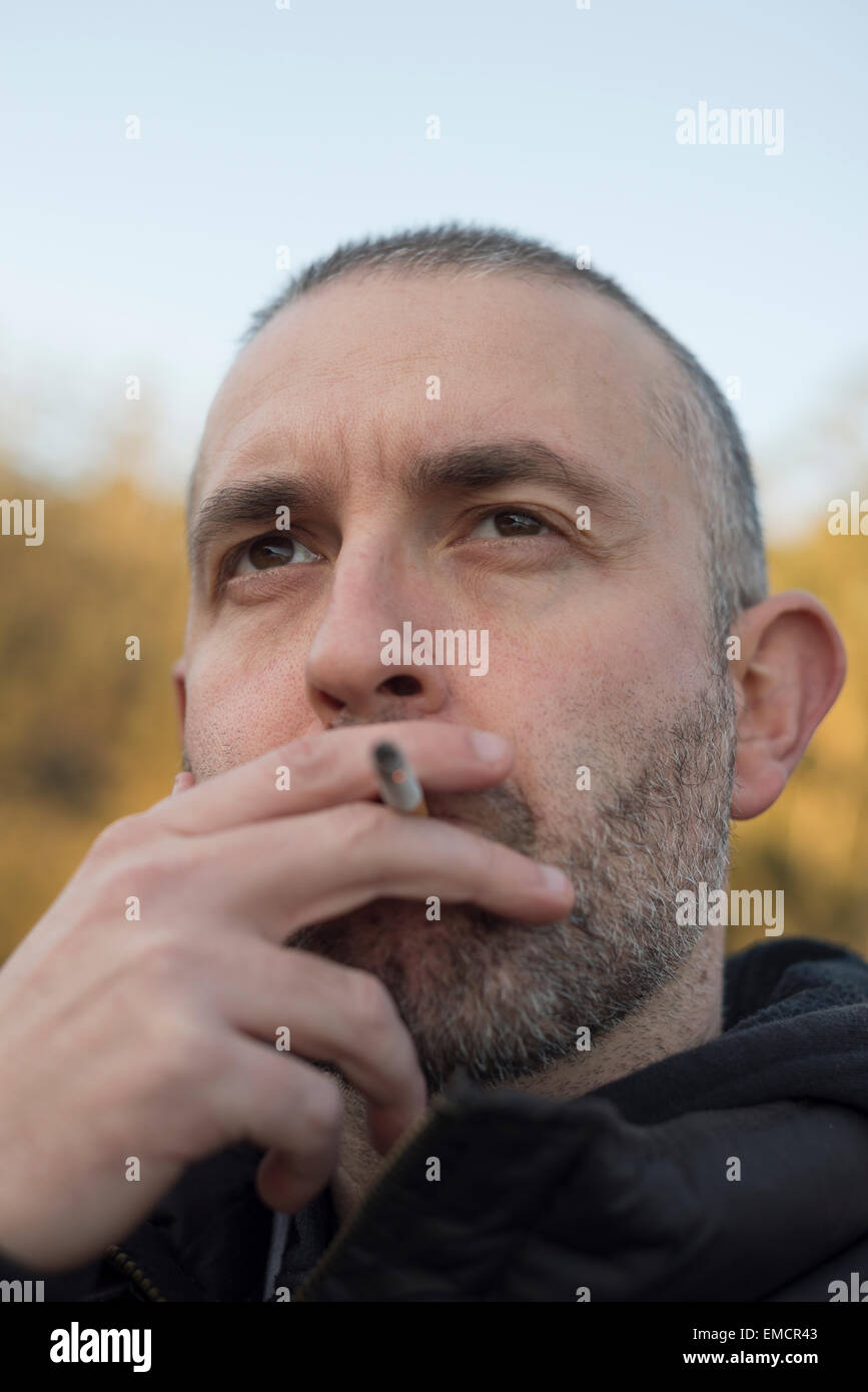 Portrait of a smoking man Stock Photo - Alamy