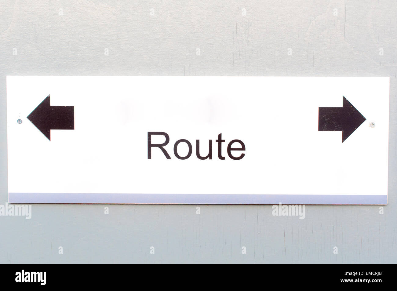 Route direction notice board on wooden background Stock Photo - Alamy
