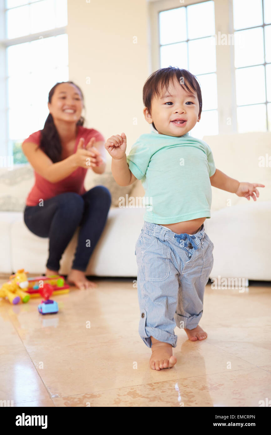 One Year Old Boy Taking First Steps With Mother Stock Photo - Alamy