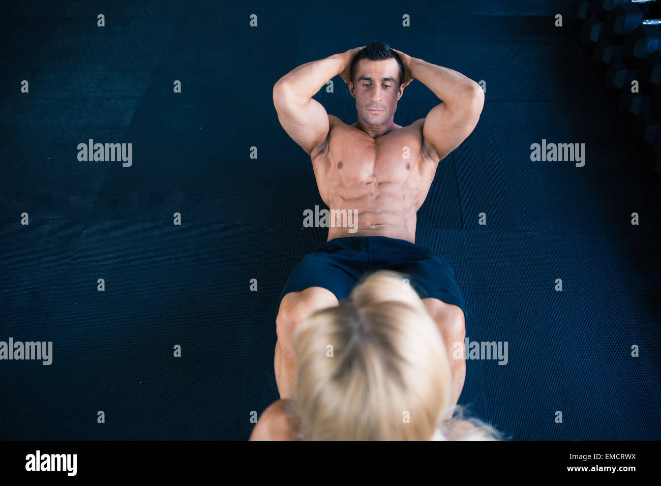 Muscular man doing abs exercise at gym Stock Photo - Alamy