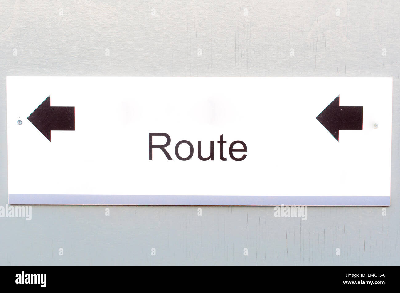 Route direction notice board on wooden background Stock Photo - Alamy