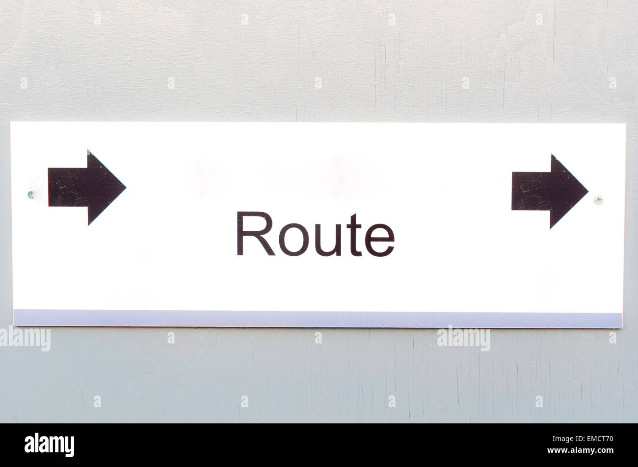 Route direction notice board on wooden background Stock Photo - Alamy