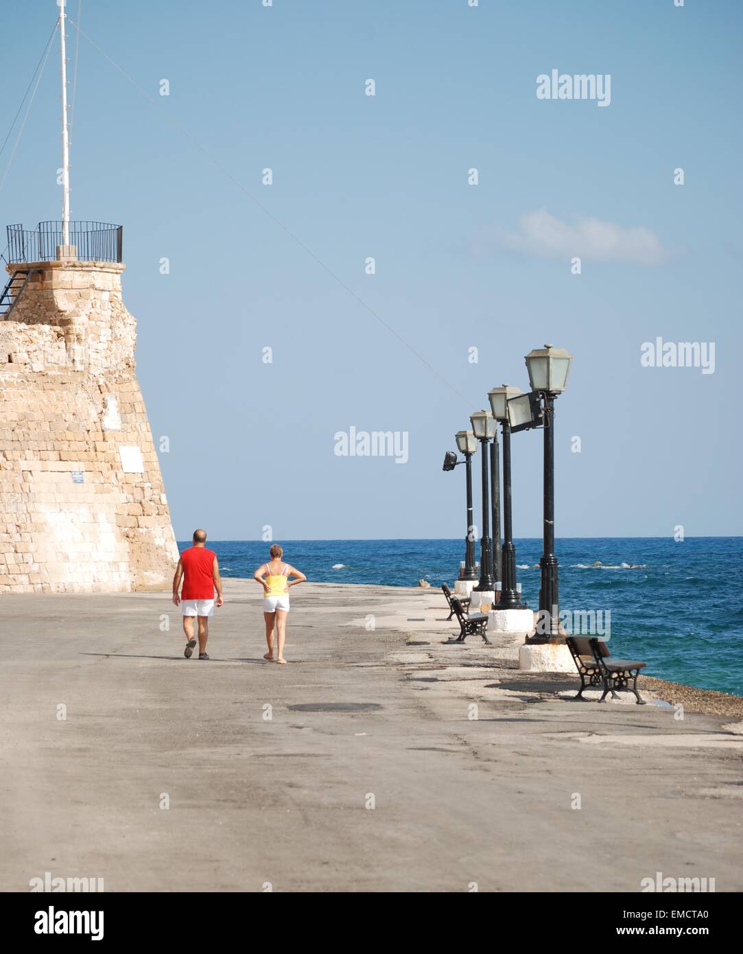 People walking along the sea wall, Chania, Crete, Greece Stock Photo ...