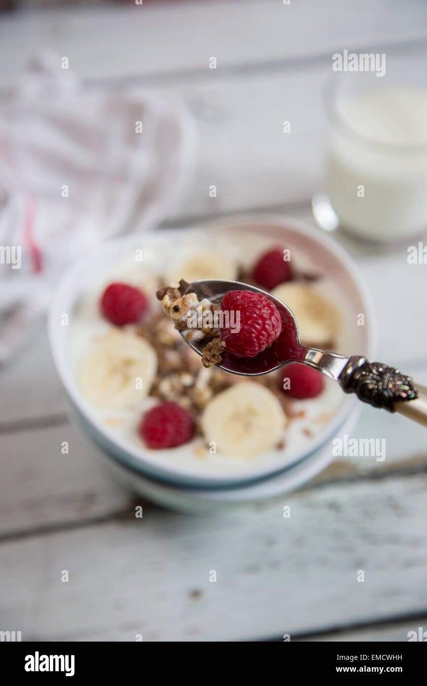 Yoghurt with muesli, raspberries and bananas Stock Photo - Alamy