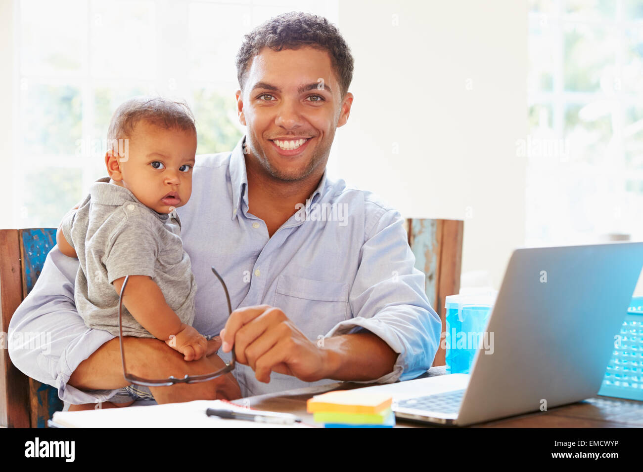 Father With Baby Working In Office At Home Stock Photo - Alamy