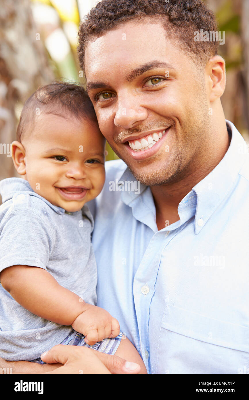 Portrait Of Smiling Father Holding Baby Son Outdoors Stock Photo - Alamy
