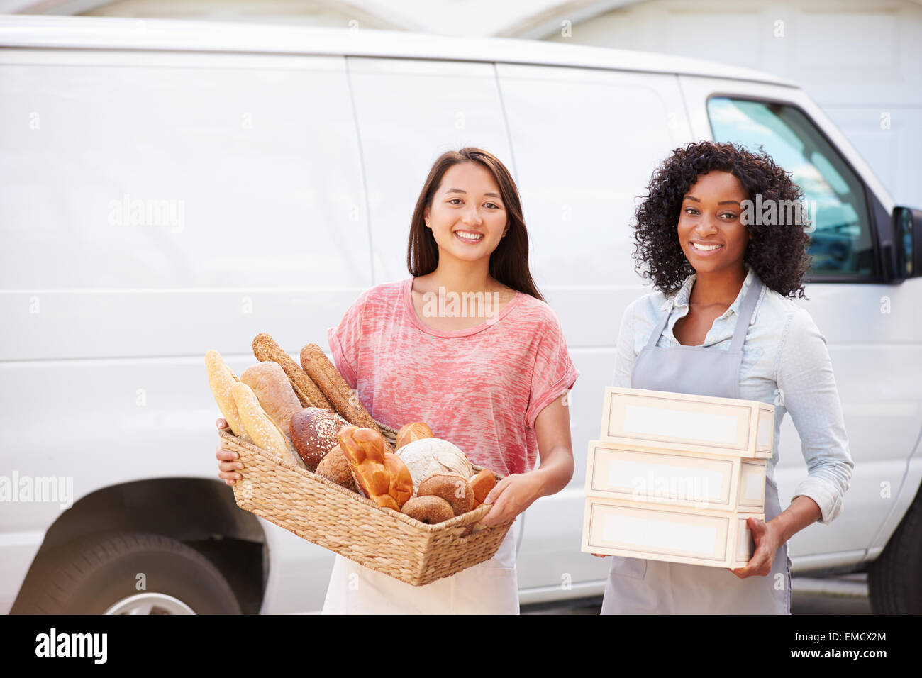 Female Bakers With Bread And Cakes Standing In Front Of Van Stock Photo ...